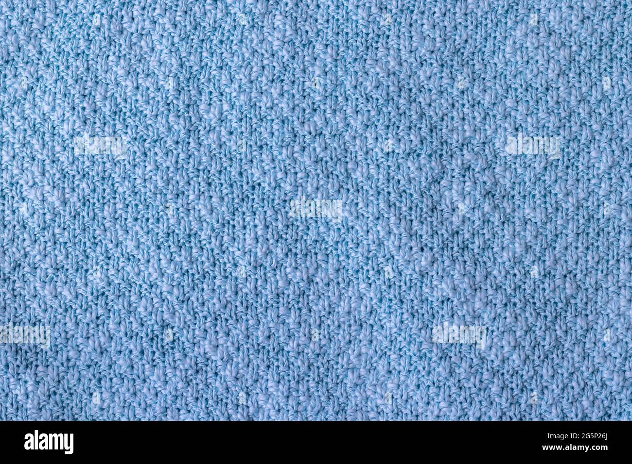Bright blue knitted fabric texture. Rough sweater background. Closeup ...