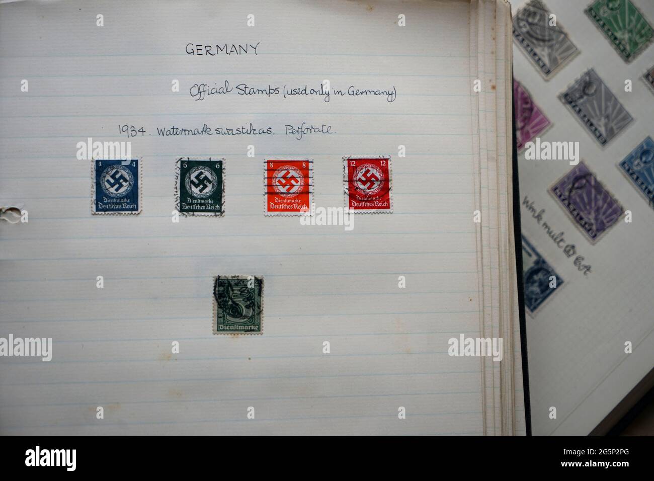 German Nazi stamps bearing the swastika in a stamp album from 1934 ...