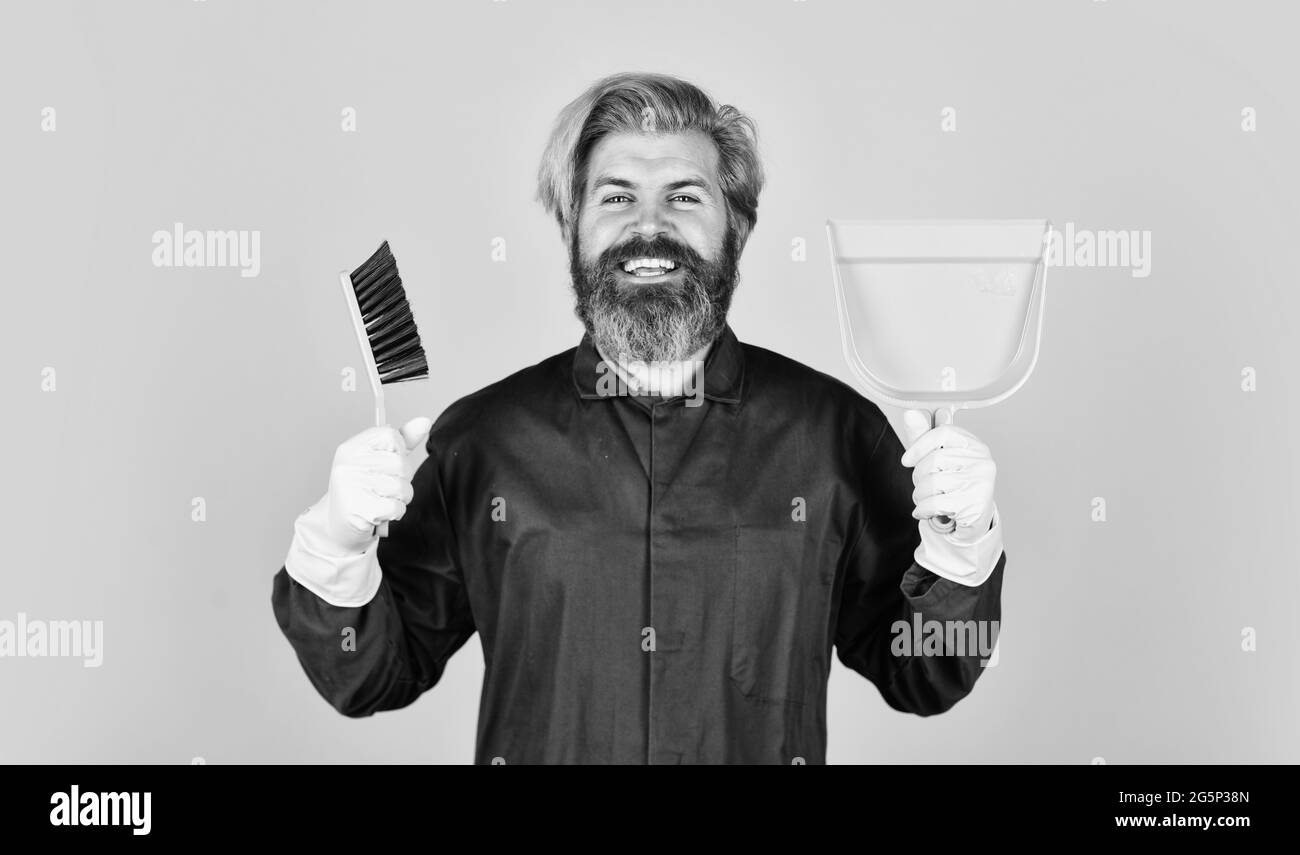 in good mood. mature male worker with broom cleaning. Male Janitor ...