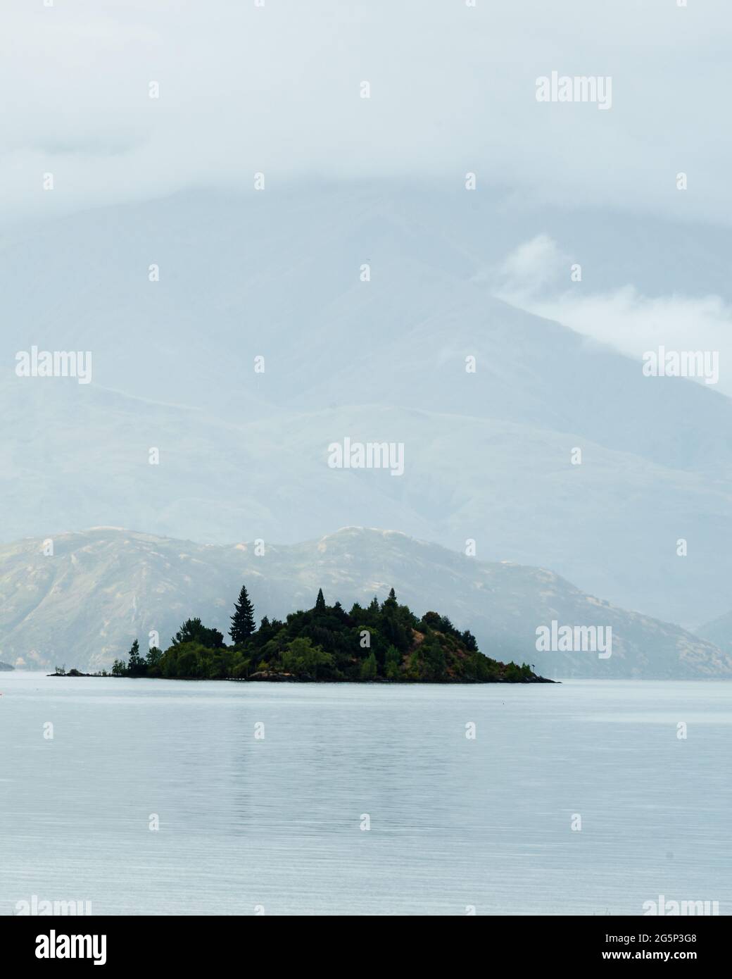 Ruby Island on Lake Wanaka with background mountains in the mist, South ...