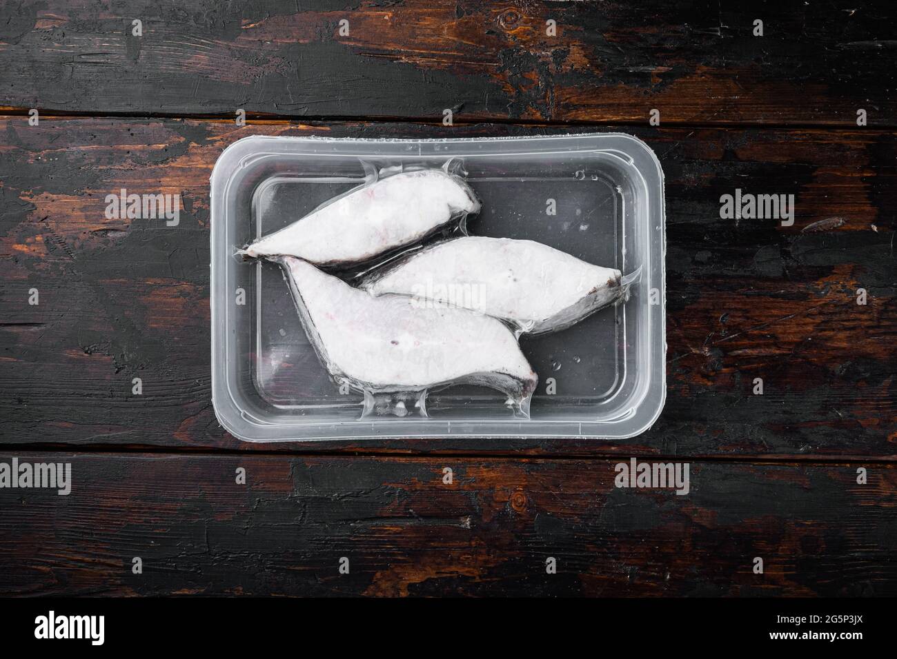 Frozen halibut pack set, on old dark wooden table background, top view ...