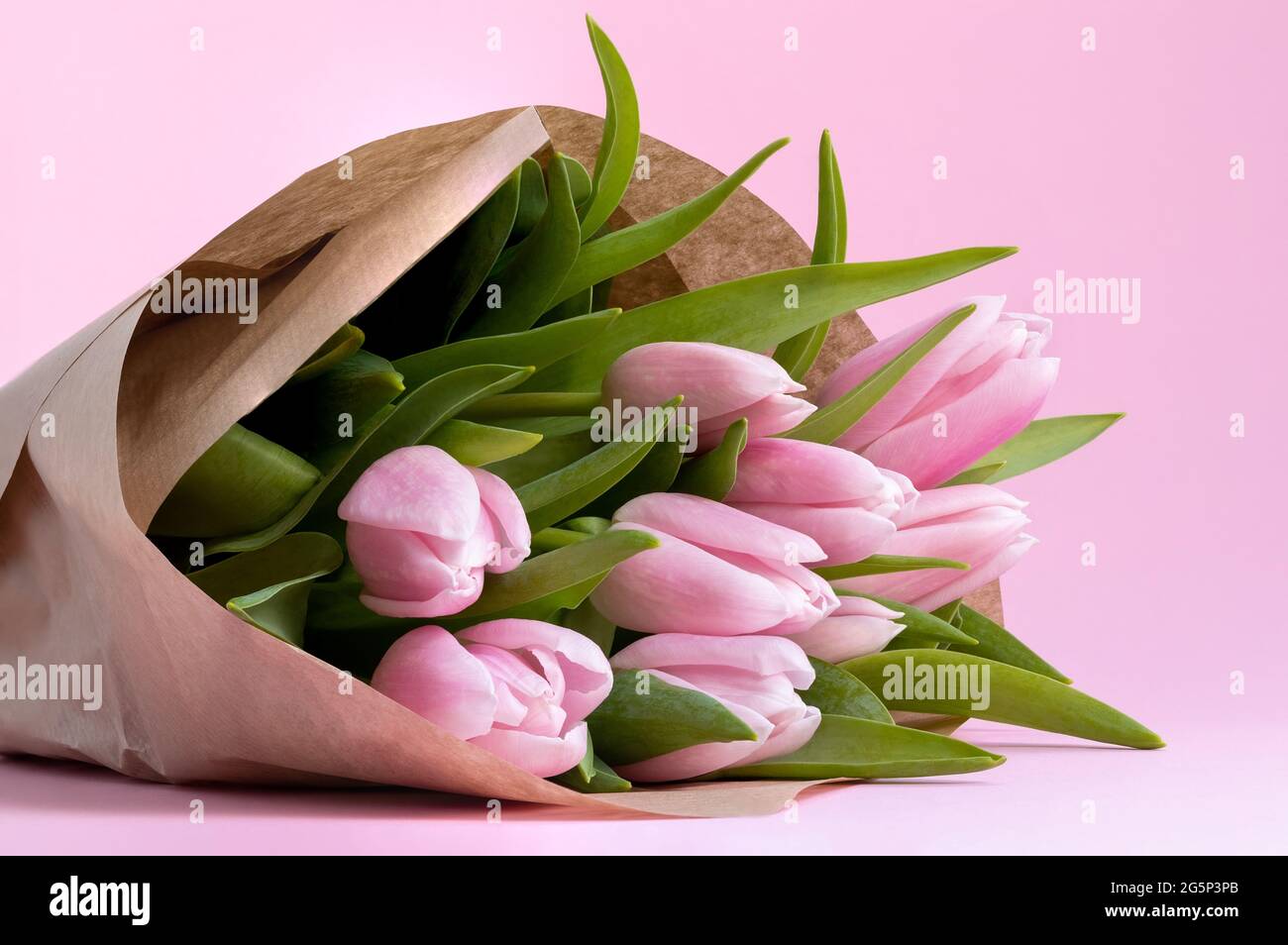 Beautiful delicate bouquet of tulip flowers in craft wrapping paper on ...