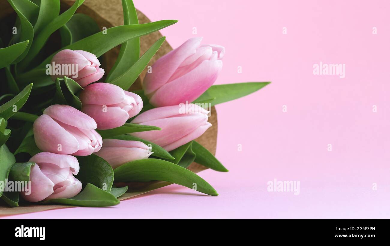 Beautiful delicate bouquet of tulip flowers in craft wrapping paper on ...
