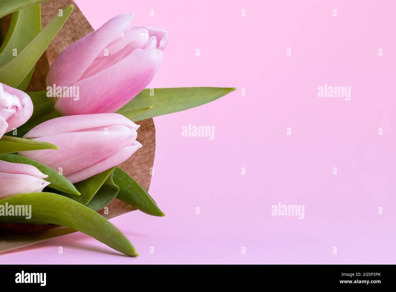 Beautiful delicate bouquet of tulip flowers in craft wrapping paper on ...