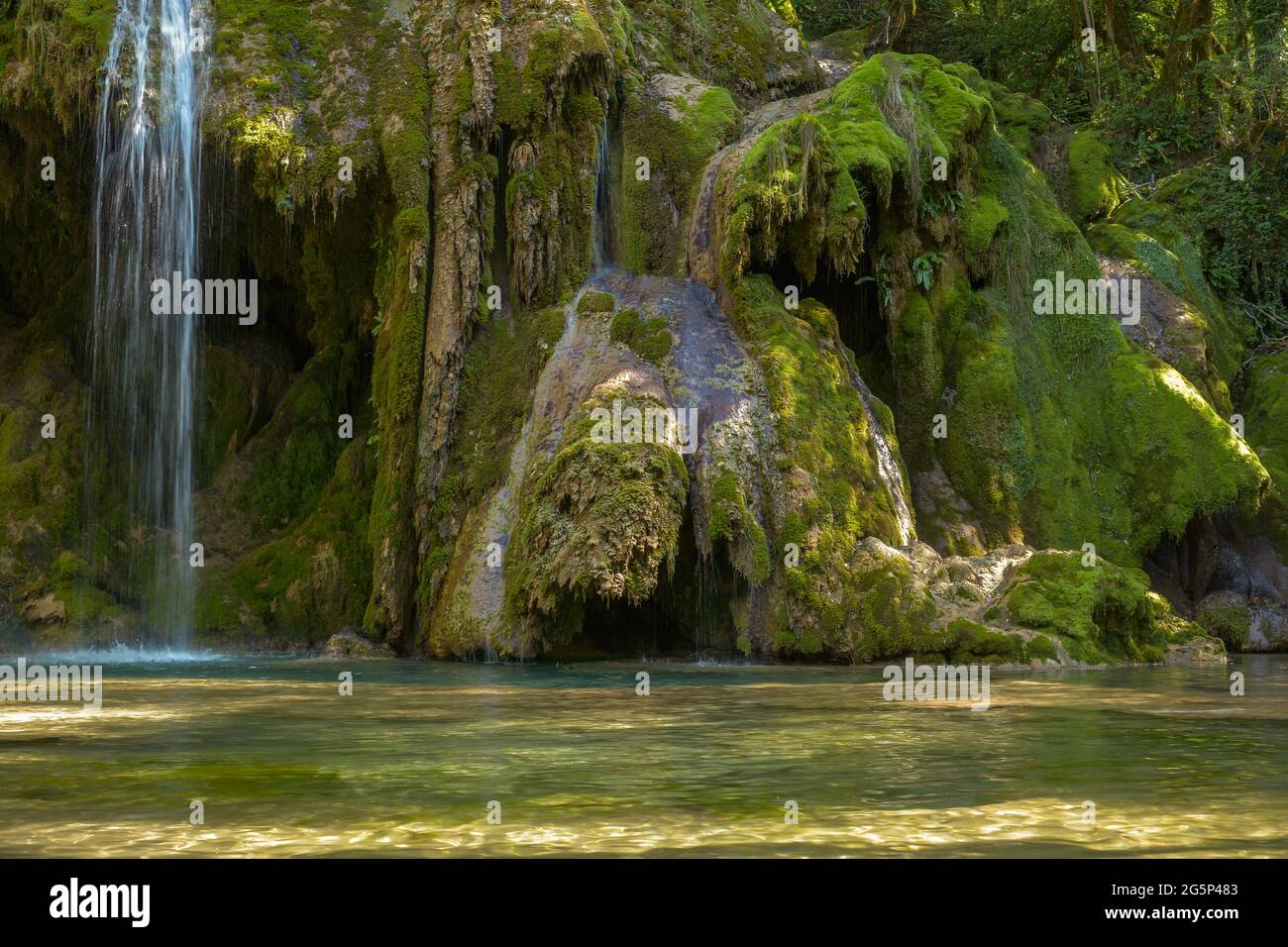 The tufa waterfall near Arbois. Crystal clear waterfall, powerful ...