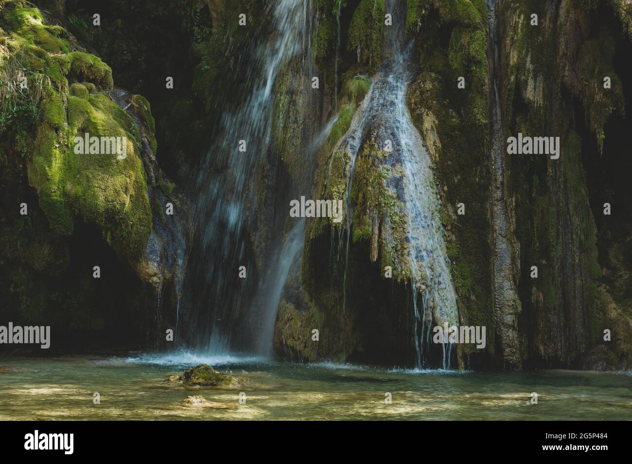 The tufa waterfall near Arbois. Crystal clear waterfall, powerful ...