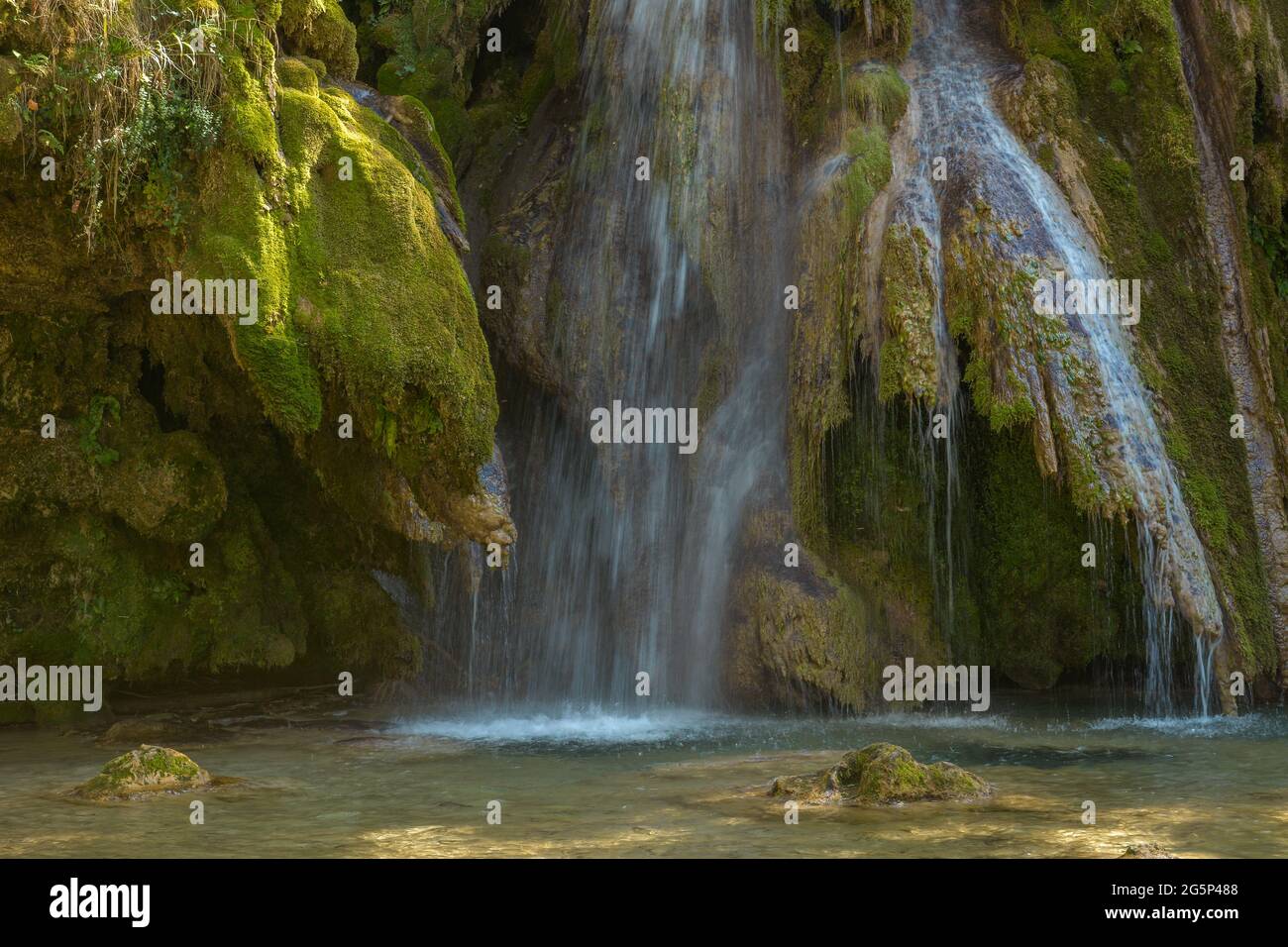 The tufa waterfall near Arbois. Crystal clear waterfall, powerful ...