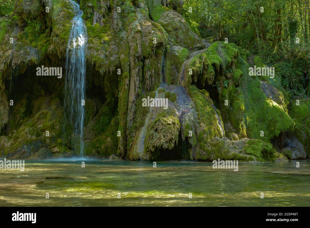 The tufa waterfall near Arbois. Crystal clear waterfall, powerful ...