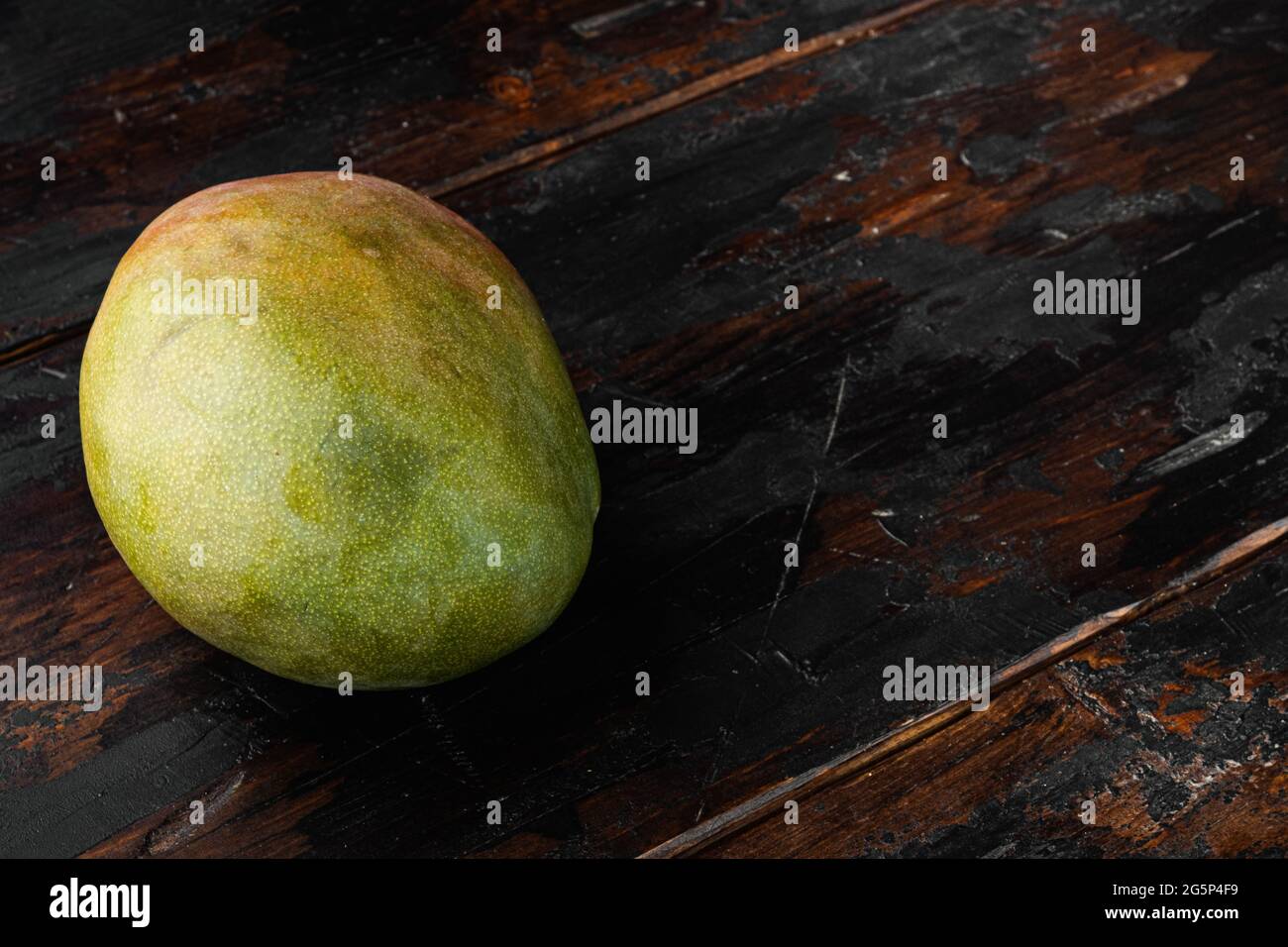 Fresh whole mango fruits set, on old dark wooden table background, with ...
