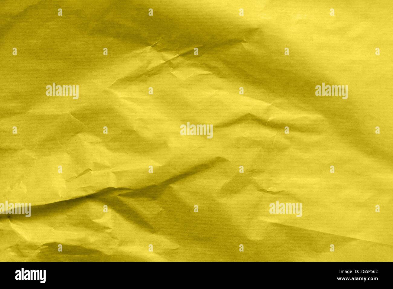 Crumpled yellow illuminating craft paper background texture Stock Photo ...
