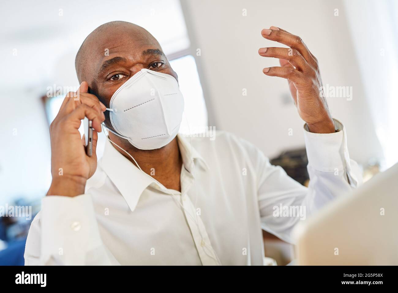 Business man with mouth and nose protection because of Covid-19 is ...