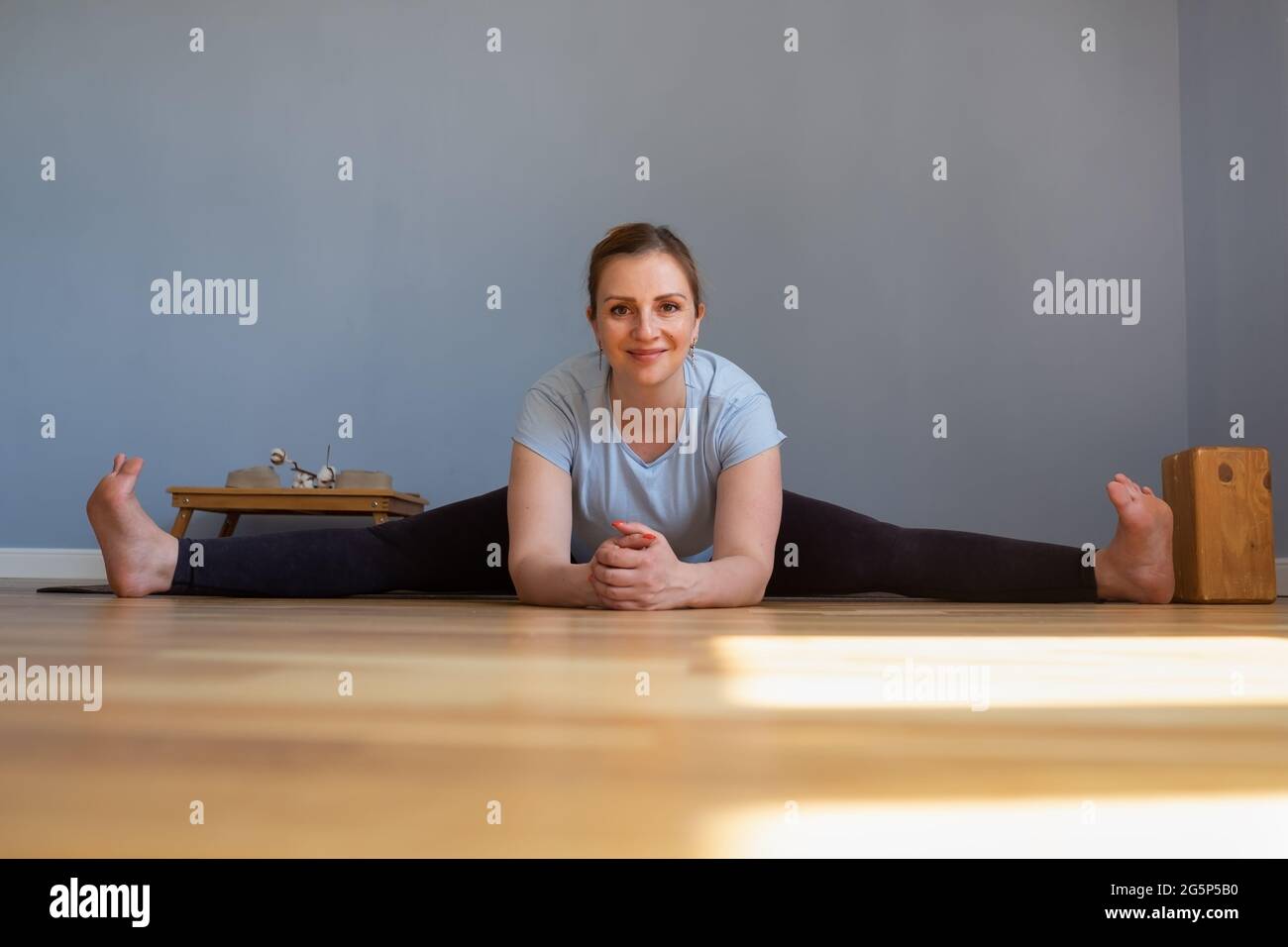 Pregnant woman working out doing Seated straddle posture, Upavishtha ...