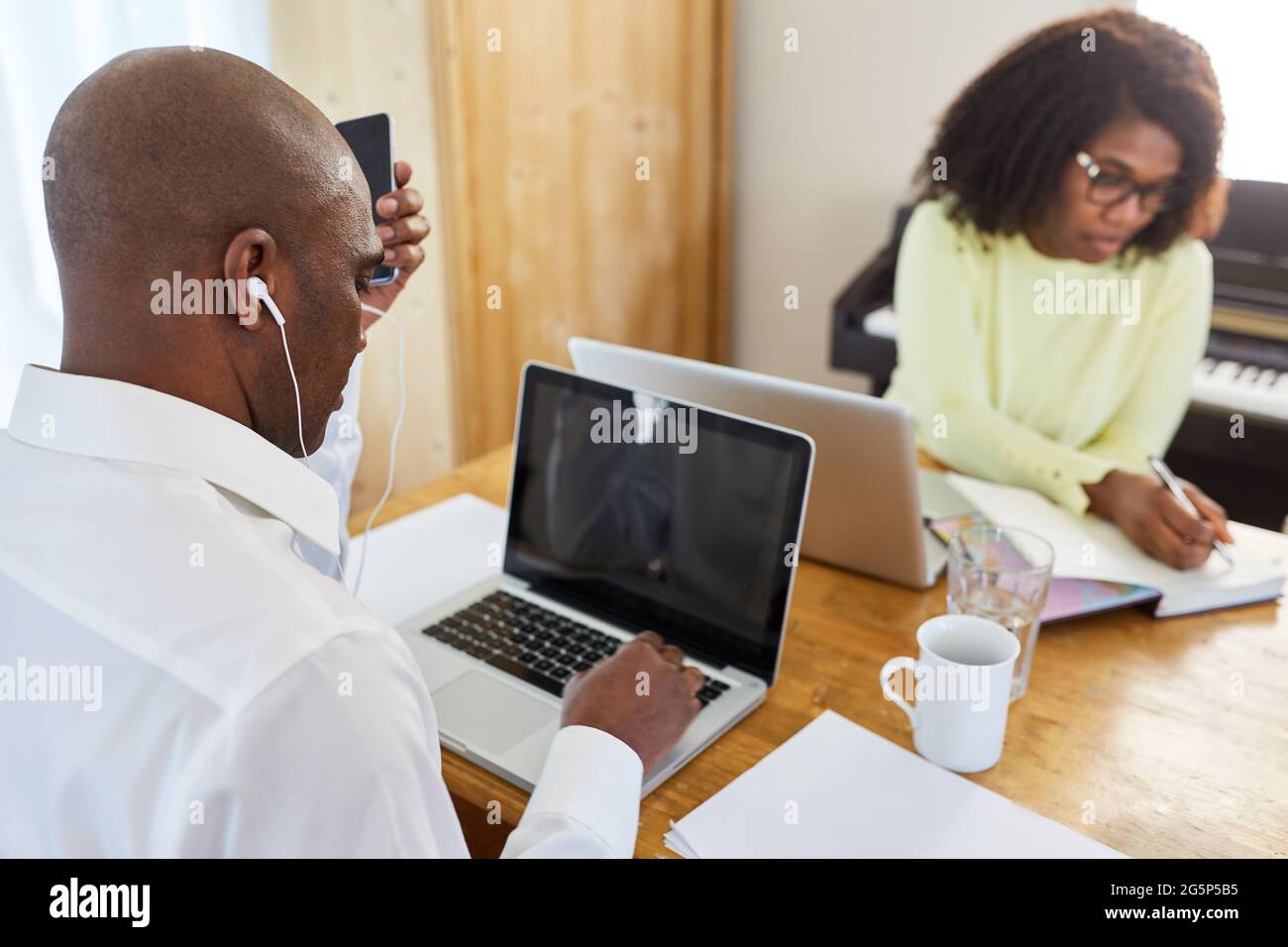African business man working on laptop computer in home office with ...