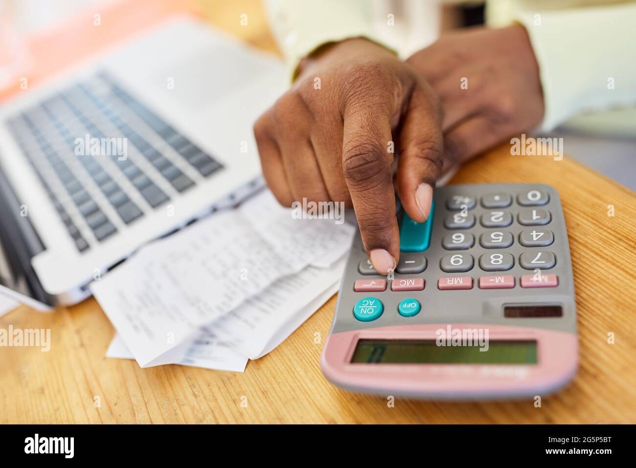 Hand typing on keyboard of calculator for accounting and tax return in ...