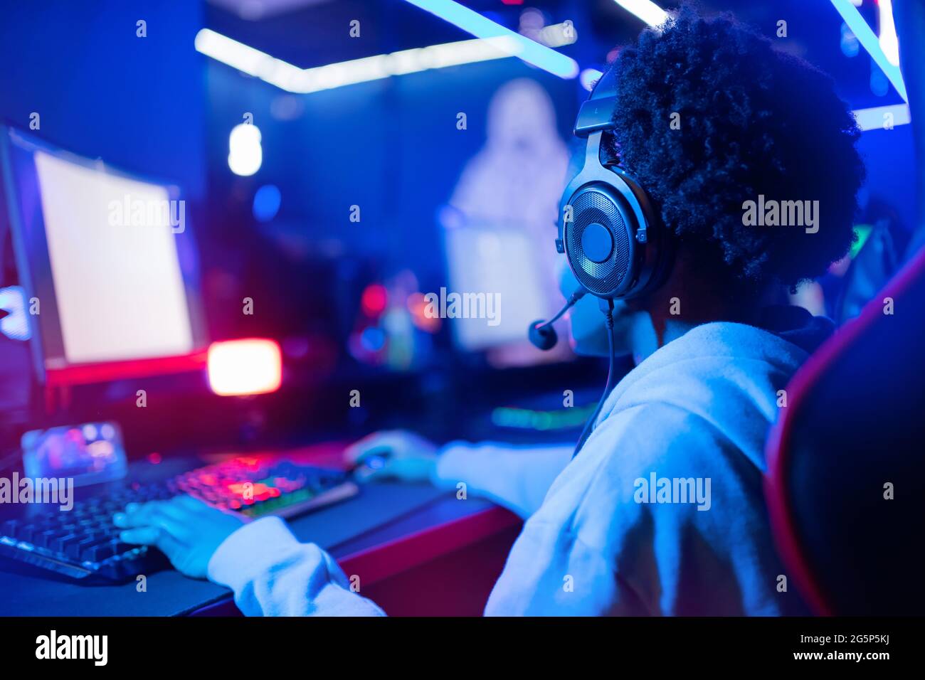 Professional Streamer African young woman cyber gamer in neon color ...