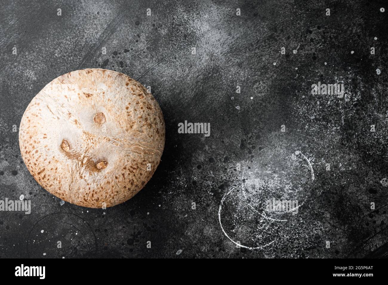 Freshly harvested coconut set, on black dark stone table background ...
