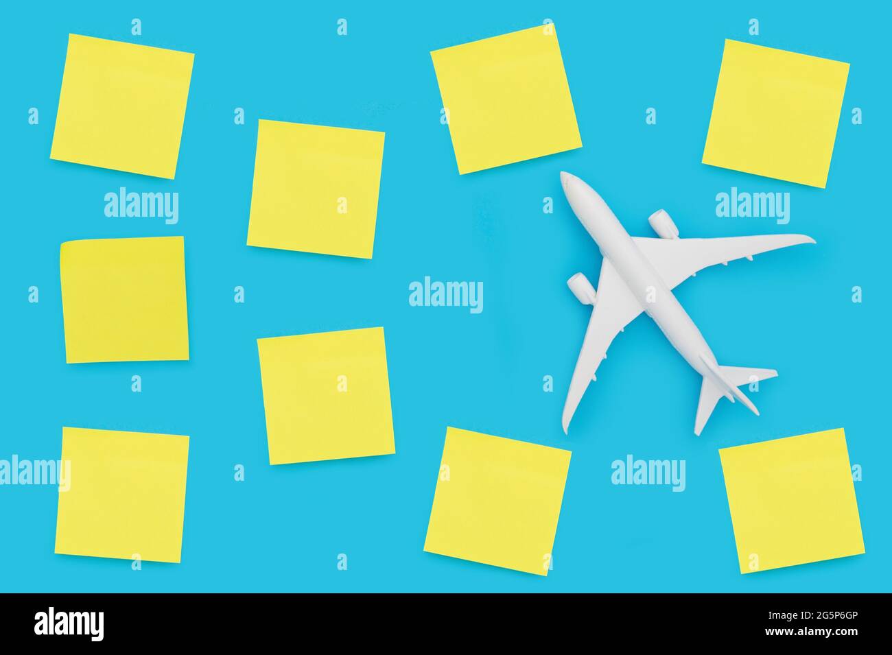 Blue background with a white airplane surrounded by yellow sticky notes ...