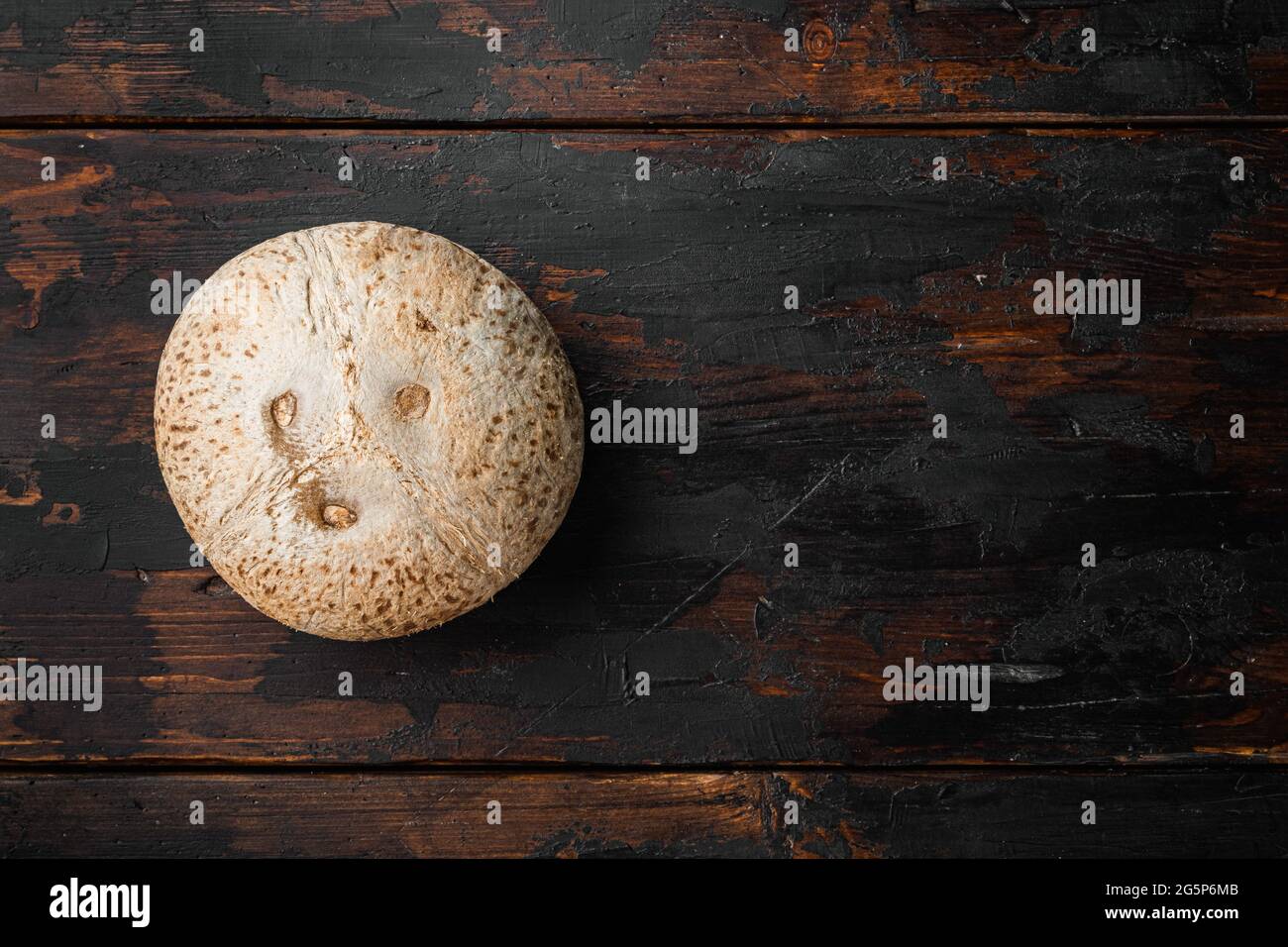 Freshly harvested coconut set, on old dark wooden table background, top ...