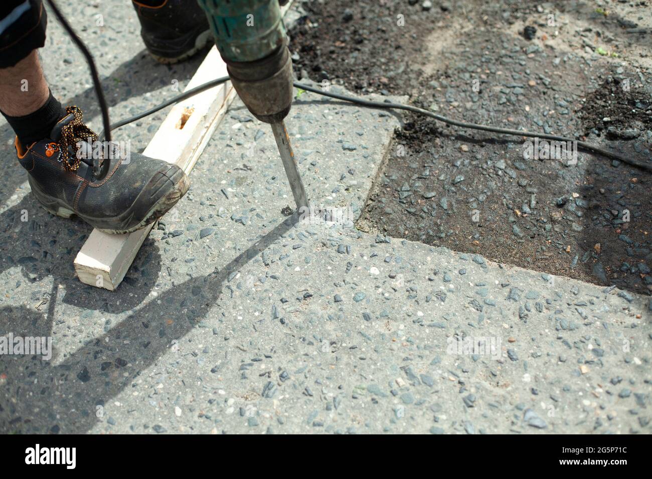 He removes the asphalt with a jackhammer. Removing the asphalt layer ...