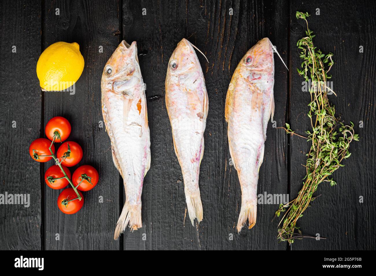 Raw surmullet whole seafood fish set, with ingredients and herbs, on ...