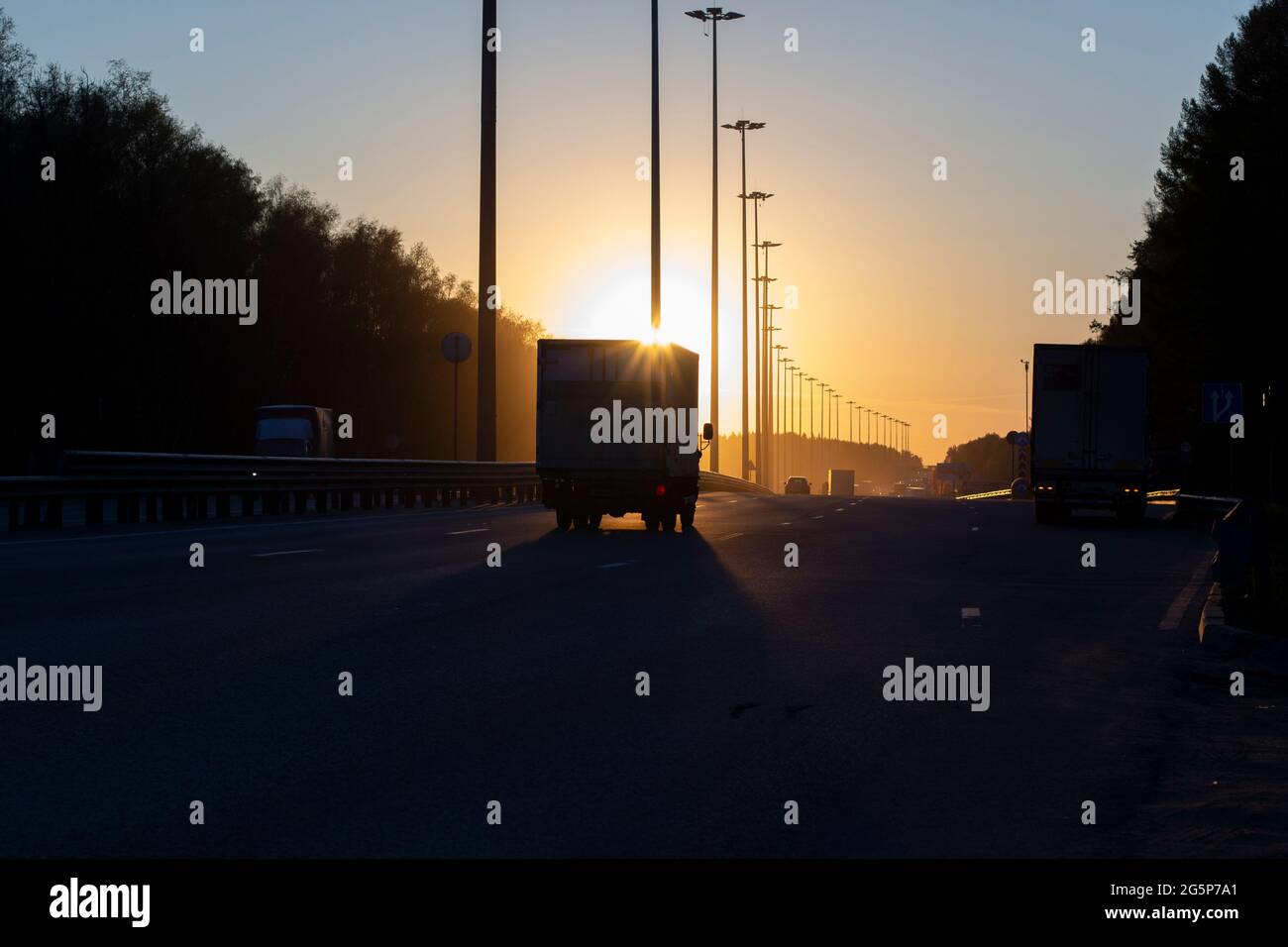 Sunset on the highway. The sun is setting over the highway. Loaded ...