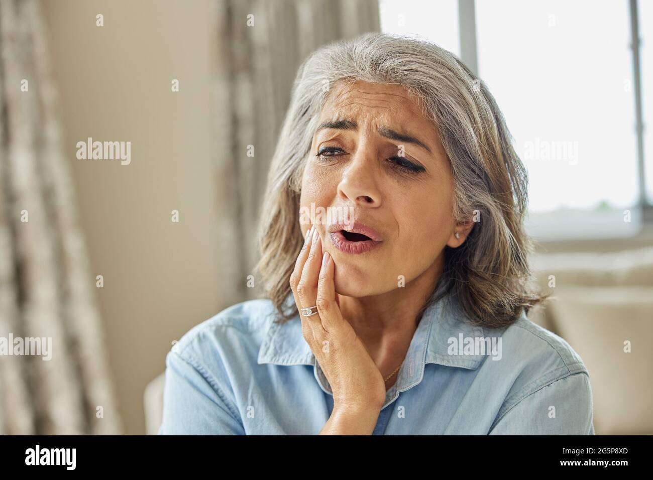 Mature Woman At Home Suffering From Pain With Toothache Stock Photo - Alamy