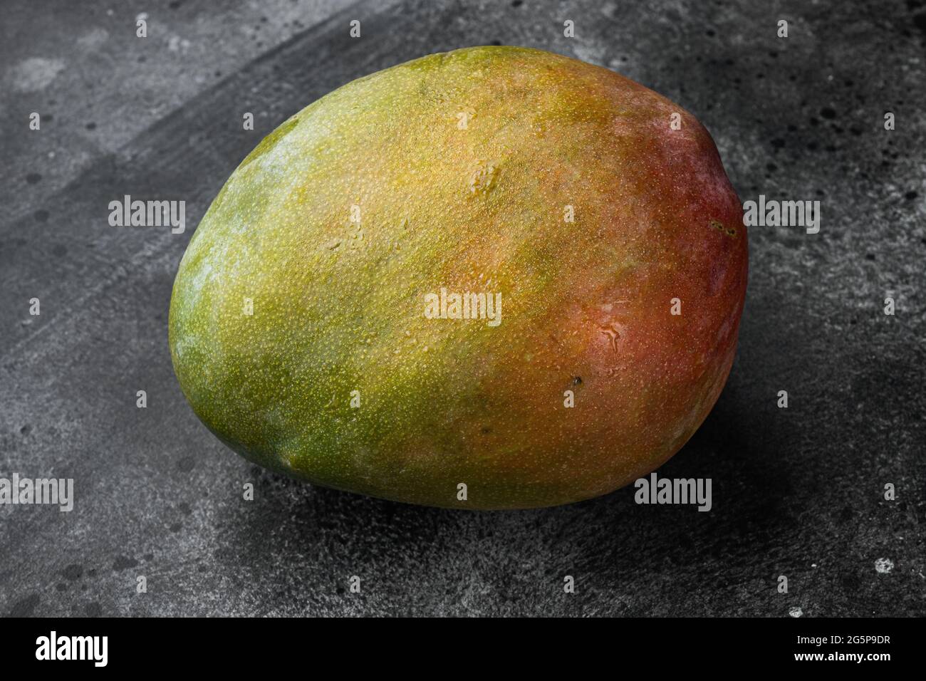 Fresh whole mango fruits set, on black dark stone table background ...