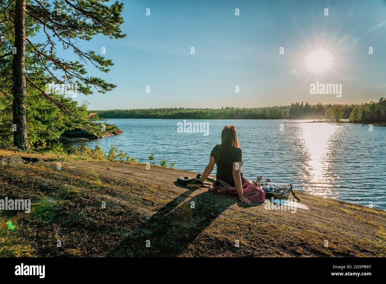Back view of woman relaxing and enjoys warm evening Sunset on flat ...