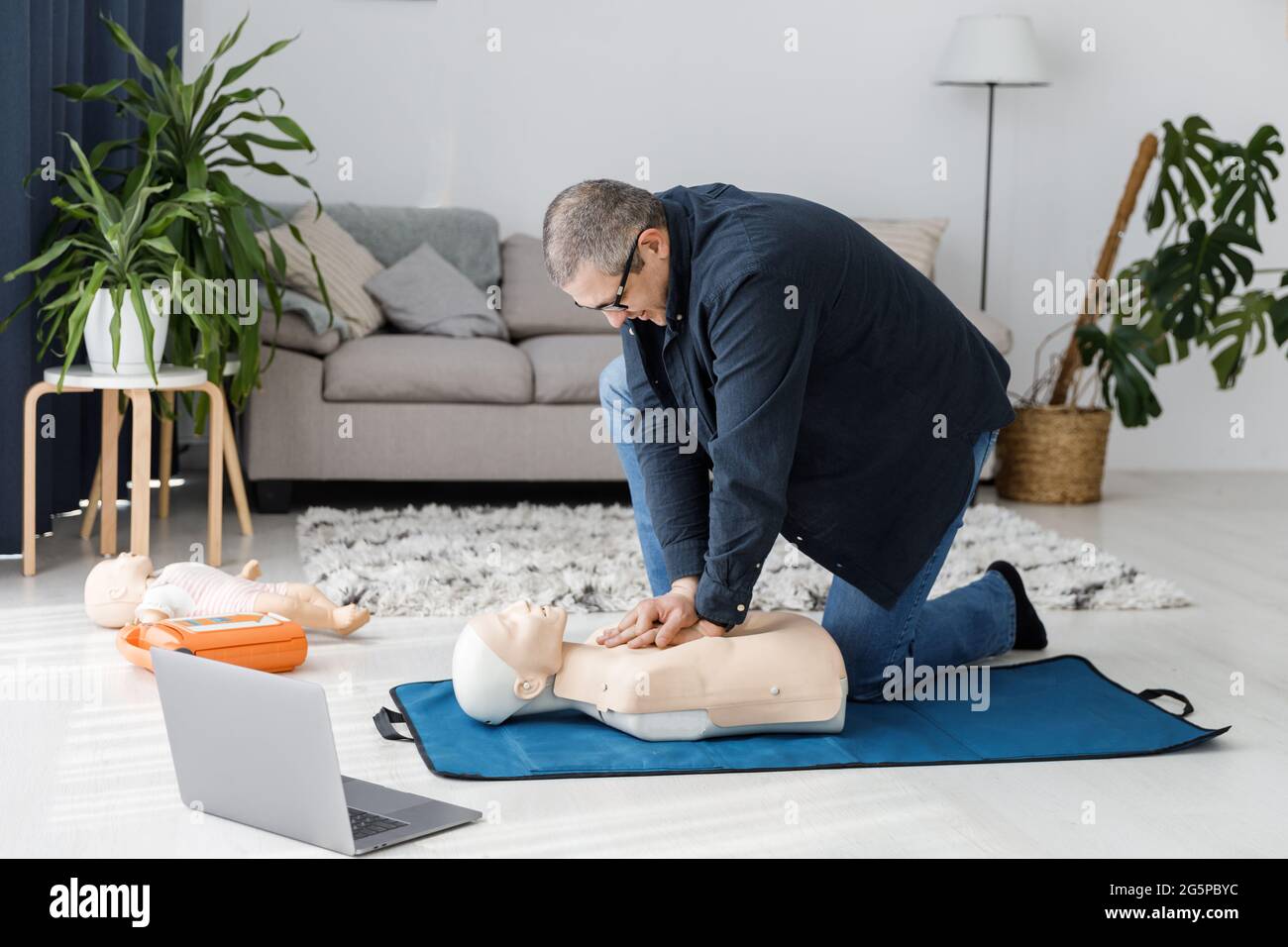 Paramedic demonstrating first aid on manikin during training alone in ...