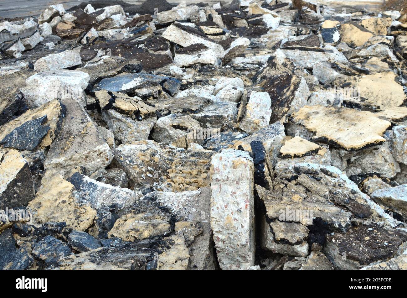 Broken pieces of asphalt at a construction site. Recycling and reuse ...