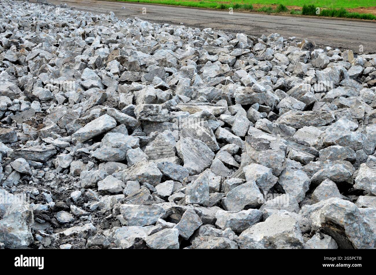 Broken pieces of asphalt at a construction site. Recycling and reuse ...