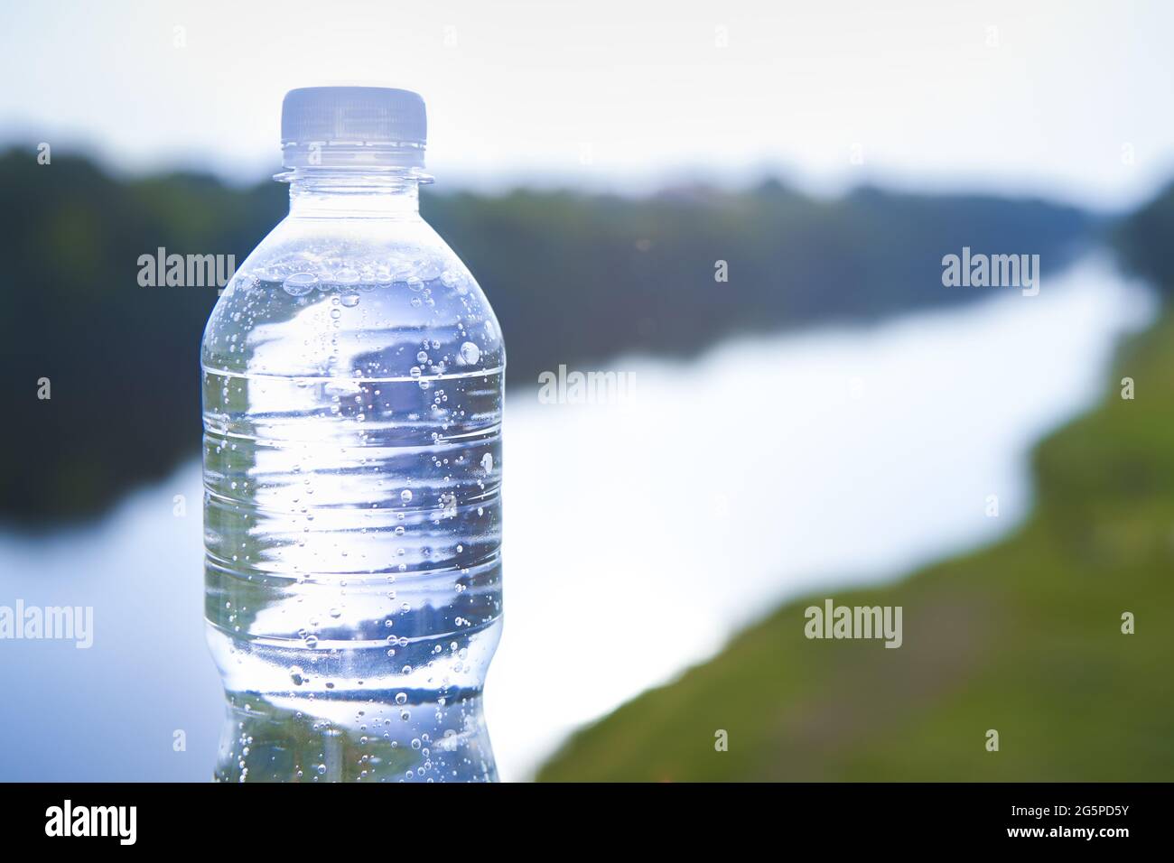 Pure transparent drinking water in a plastic bottle against the ...