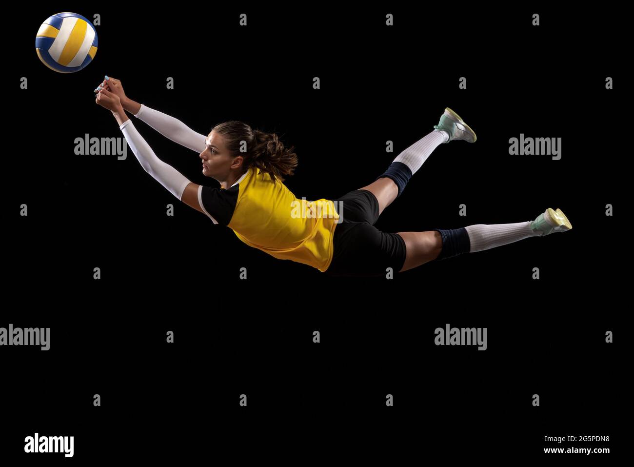 Female professional volleyball player with ball isolated on black ...