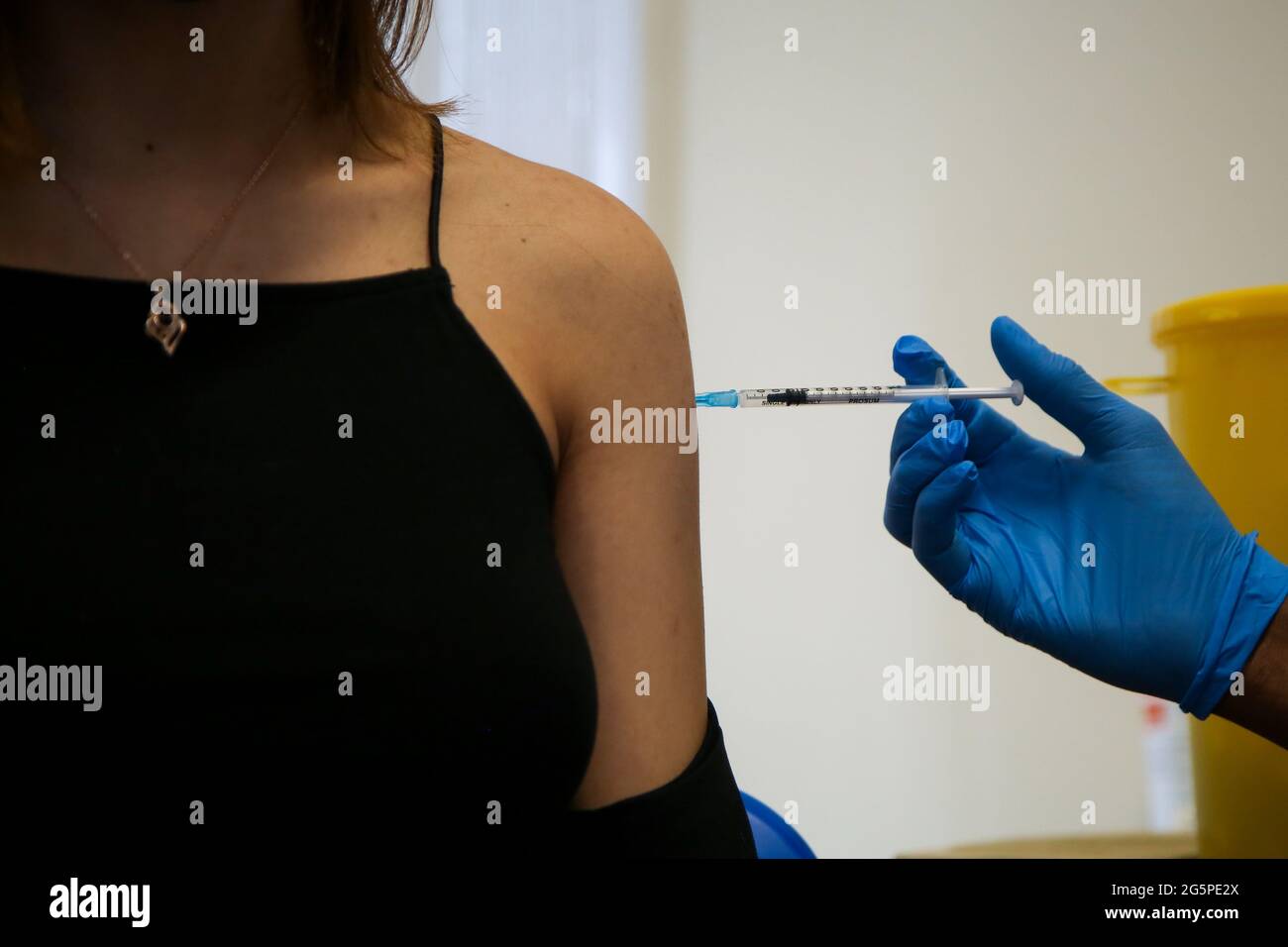 London, UK. 25th June, 2021. A NHS health worker administers a dose of ...