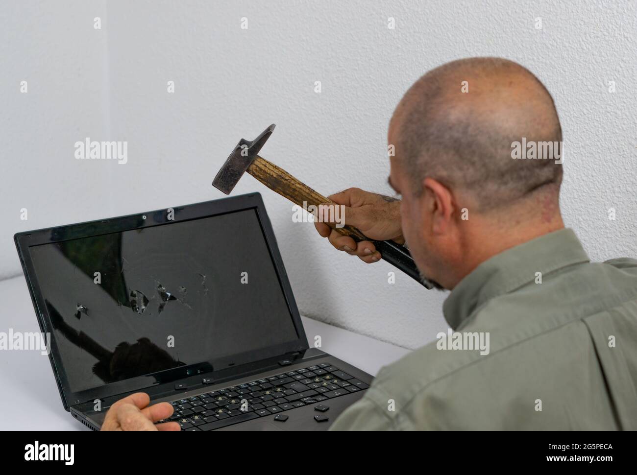 man breaking pc with hammer Stock Photo - Alamy