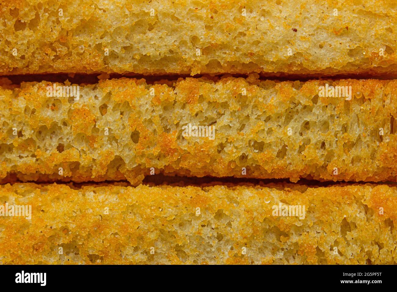 Homemade slices of bread croutons. Wheat rye rusks. Baked bread snacks ...
