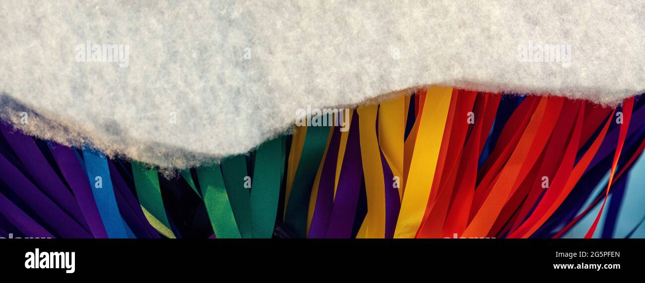 Banner from the decoration of cloud with rain from colored ribbons as ...