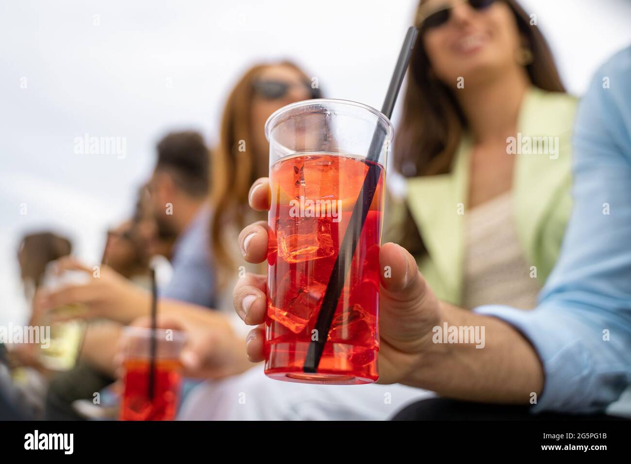 Gathering of best friends having fun talking and drinking cocktails ...