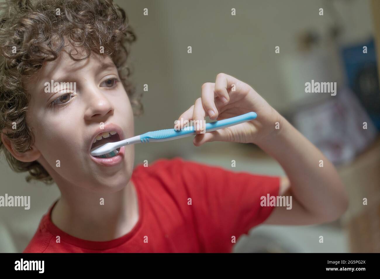 Little boy washing teeth in the bathroom Stock Photo - Alamy