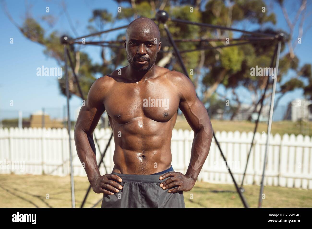 Portrait of fit african american man exercising outdoors, taking a ...