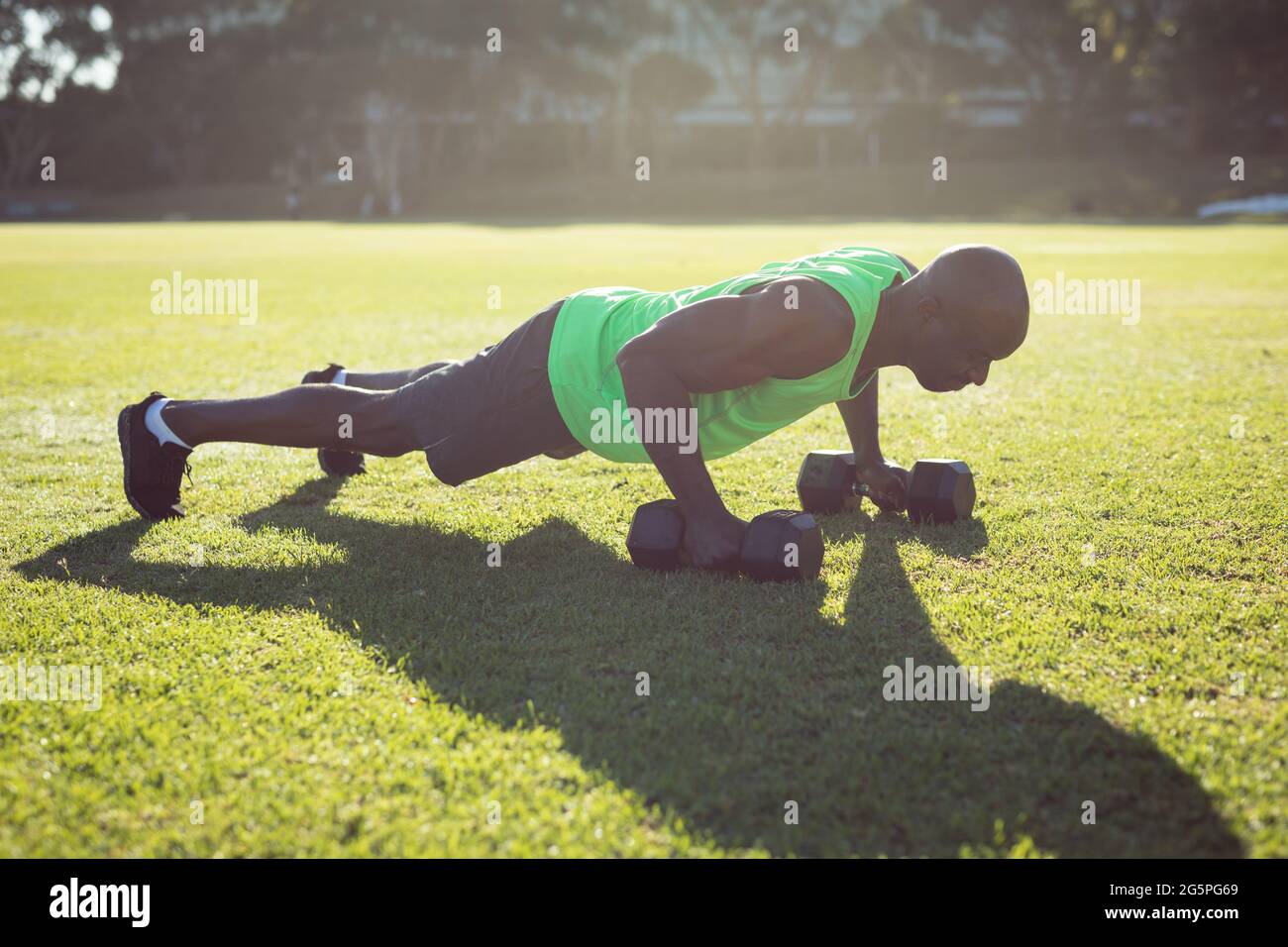 African american muscular man exercising outdoors with dumbbells Stock ...