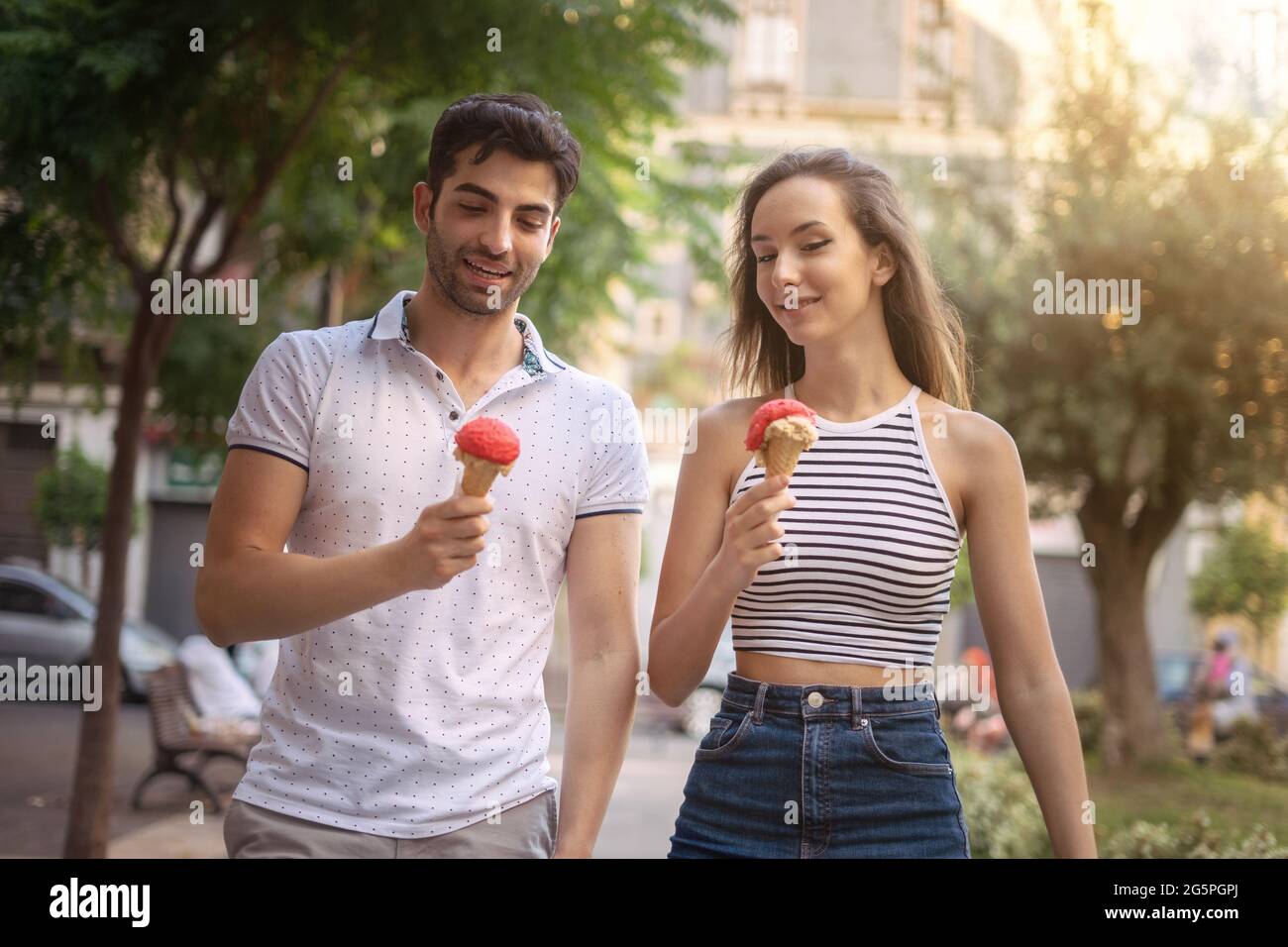 Man and woman walking eating ice cream hi-res stock photography and ...