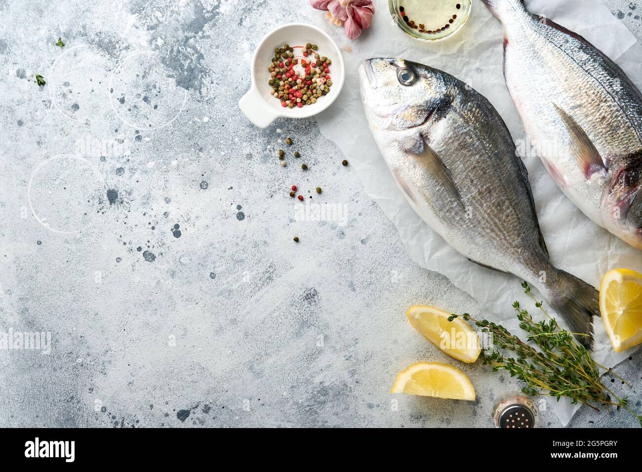 Raw dorado fresh fish or sea bream with ingredients for making lemon ...