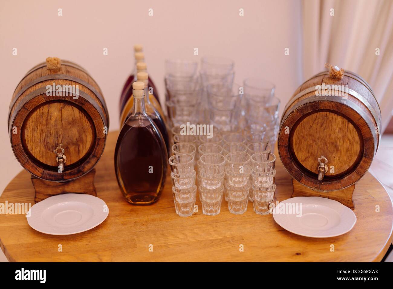 Two barrels of local traditional alcoholic beverages and several glass ...