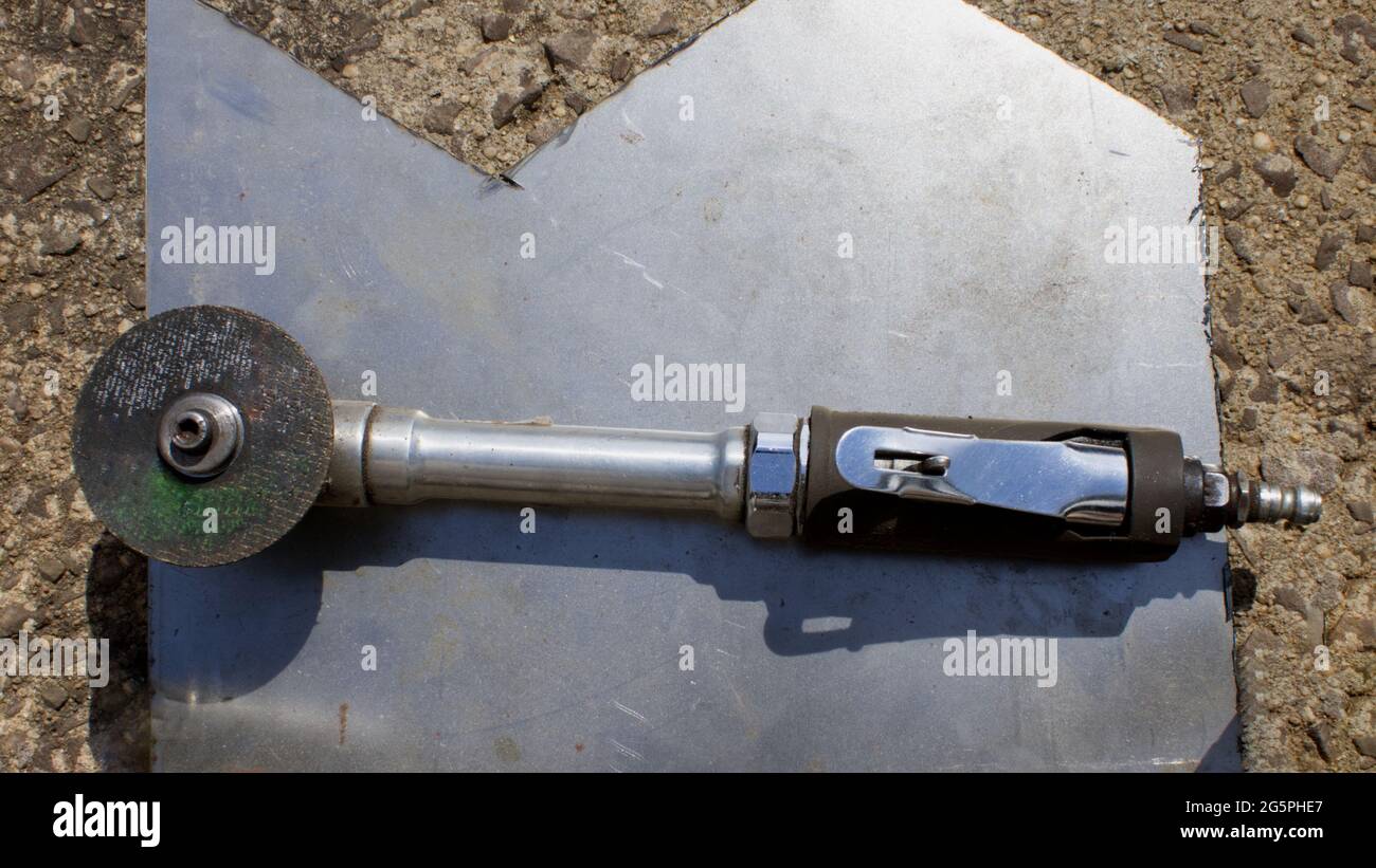 A Air Angle Cut Off Tool and a Piece of Cut Sheet Metal Stock Photo - Alamy