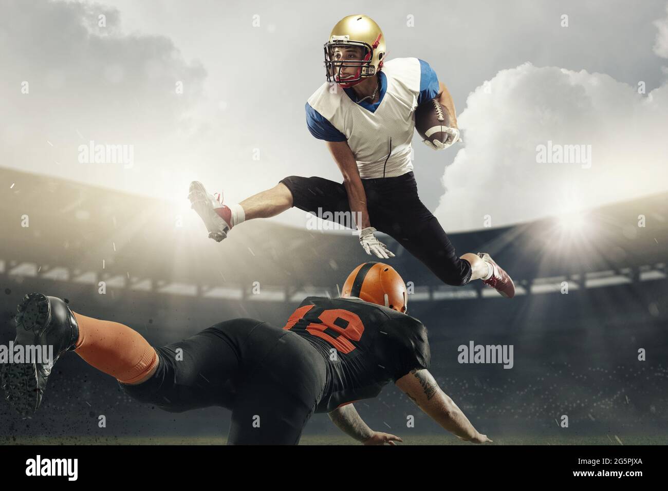 Two professional american football players at stadium in motion at ...