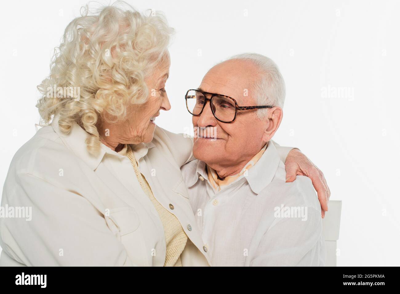 happy elderly couple gently hugging isolated on white Stock Photo - Alamy