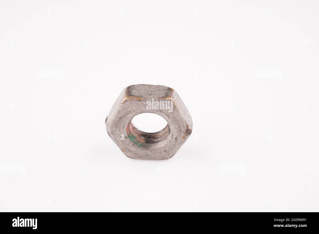 old metal nuts on a white background Stock Photo - Alamy
