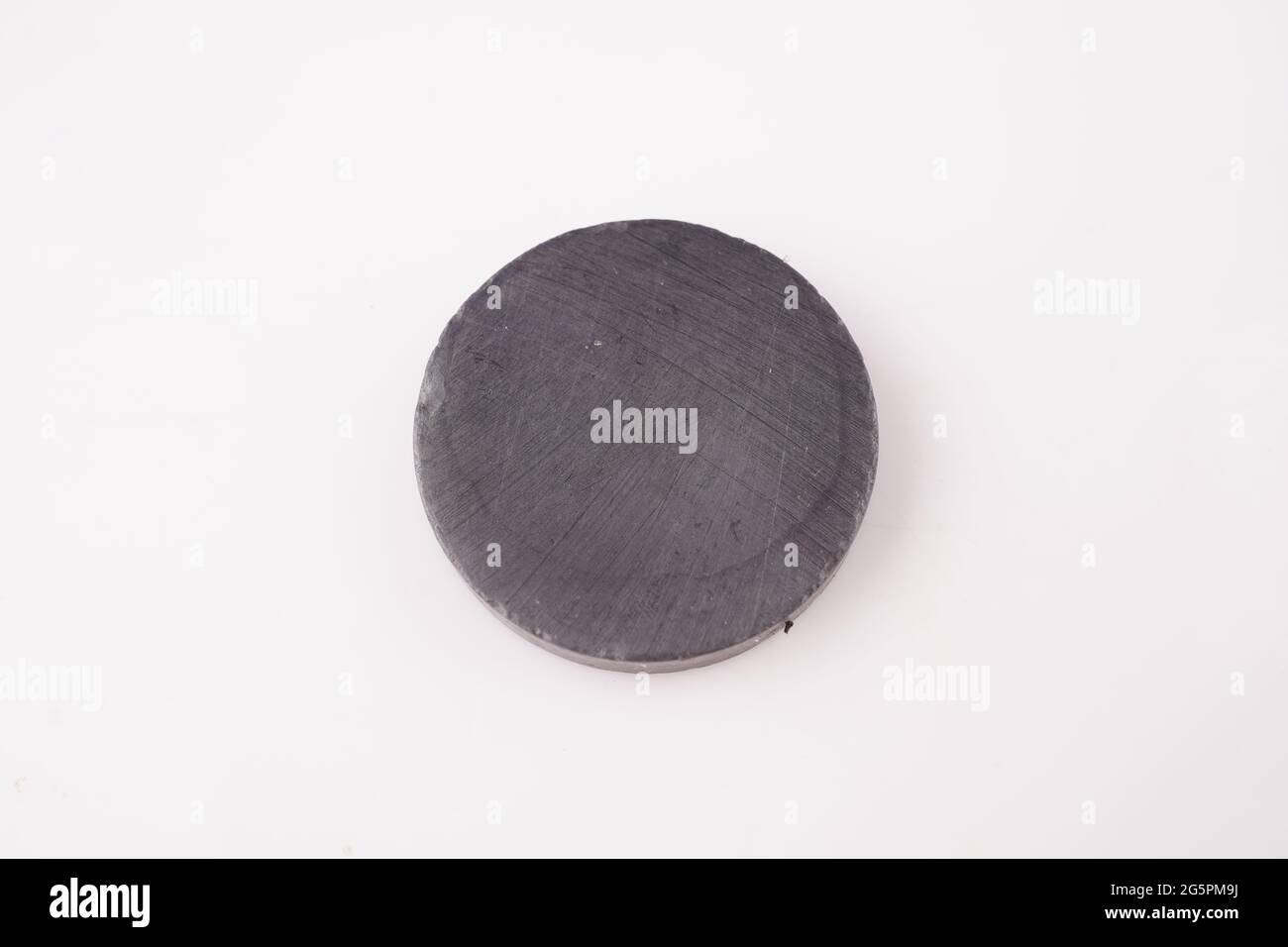 black round magnet on a white background Stock Photo - Alamy