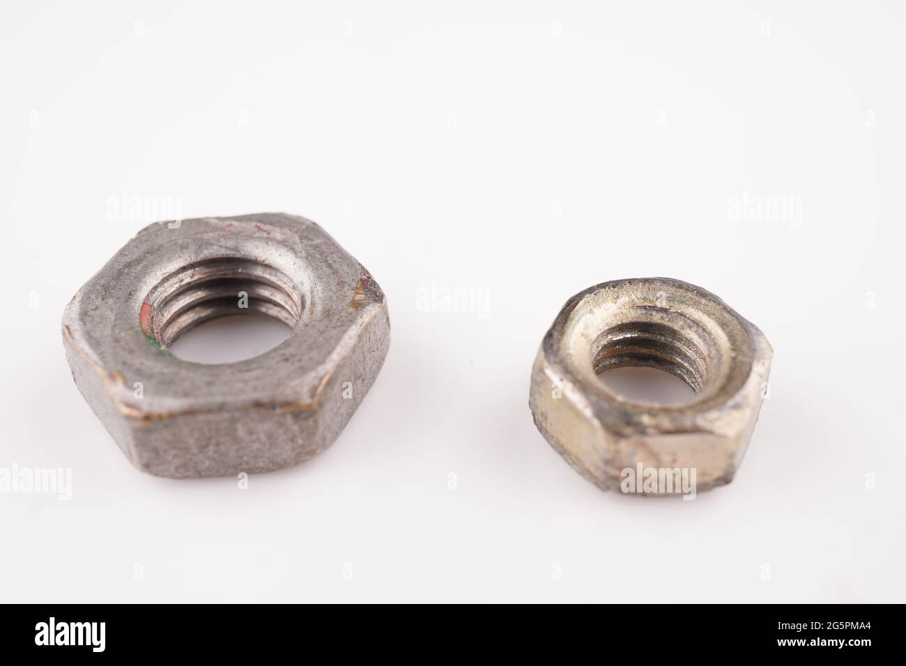 old metal nuts on a white background Stock Photo - Alamy